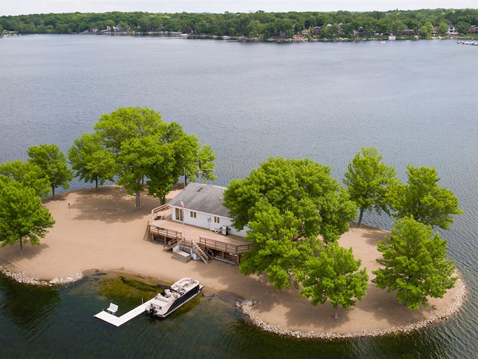 Aerial view of paradise: Lone Tree Island emerges from O'Dowd Lake like a private Eden, complete with sandy shores and verdant trees.