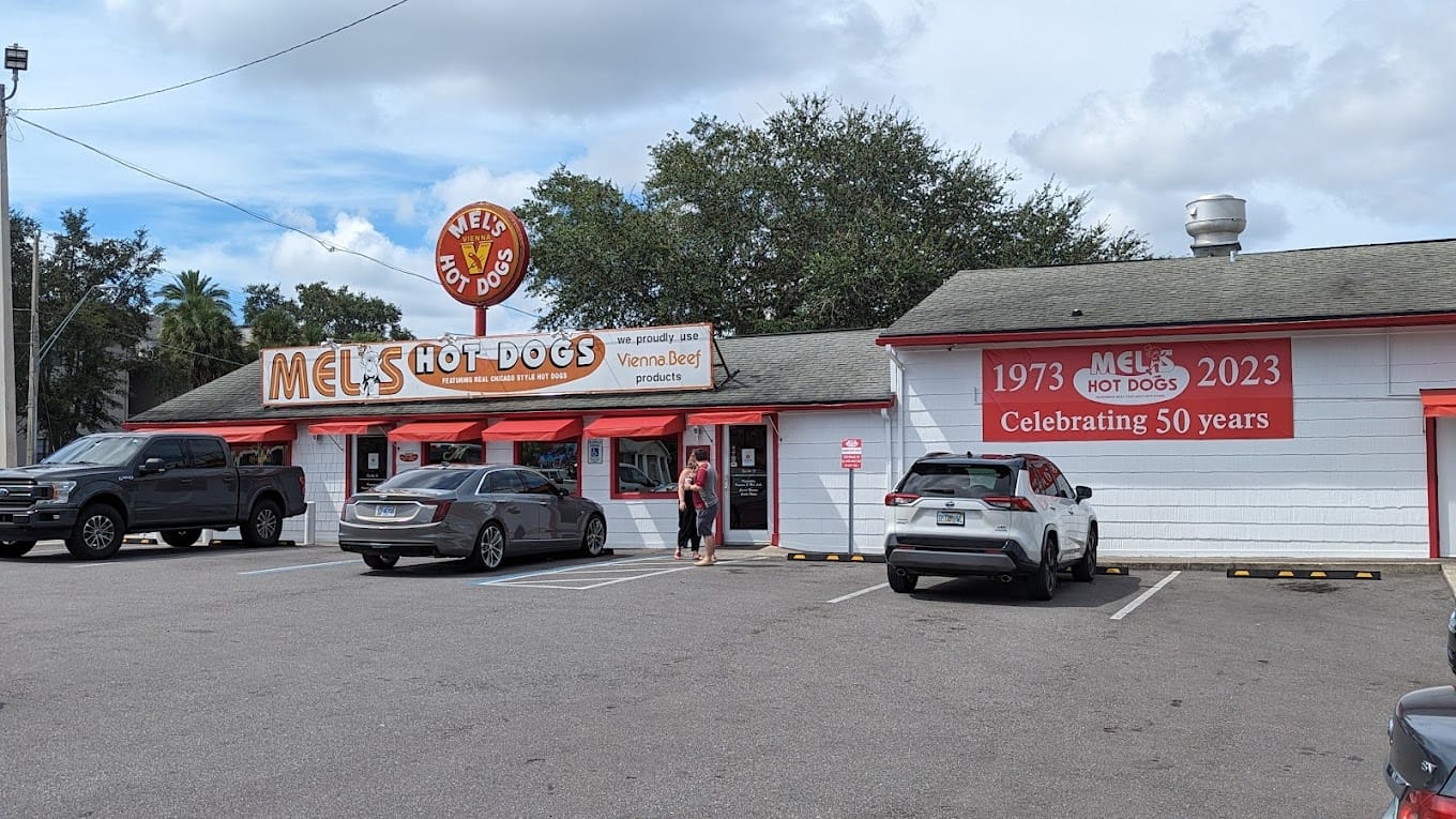 the exterior of mels hot dogs with its iconic sign celebrating 50 years in business