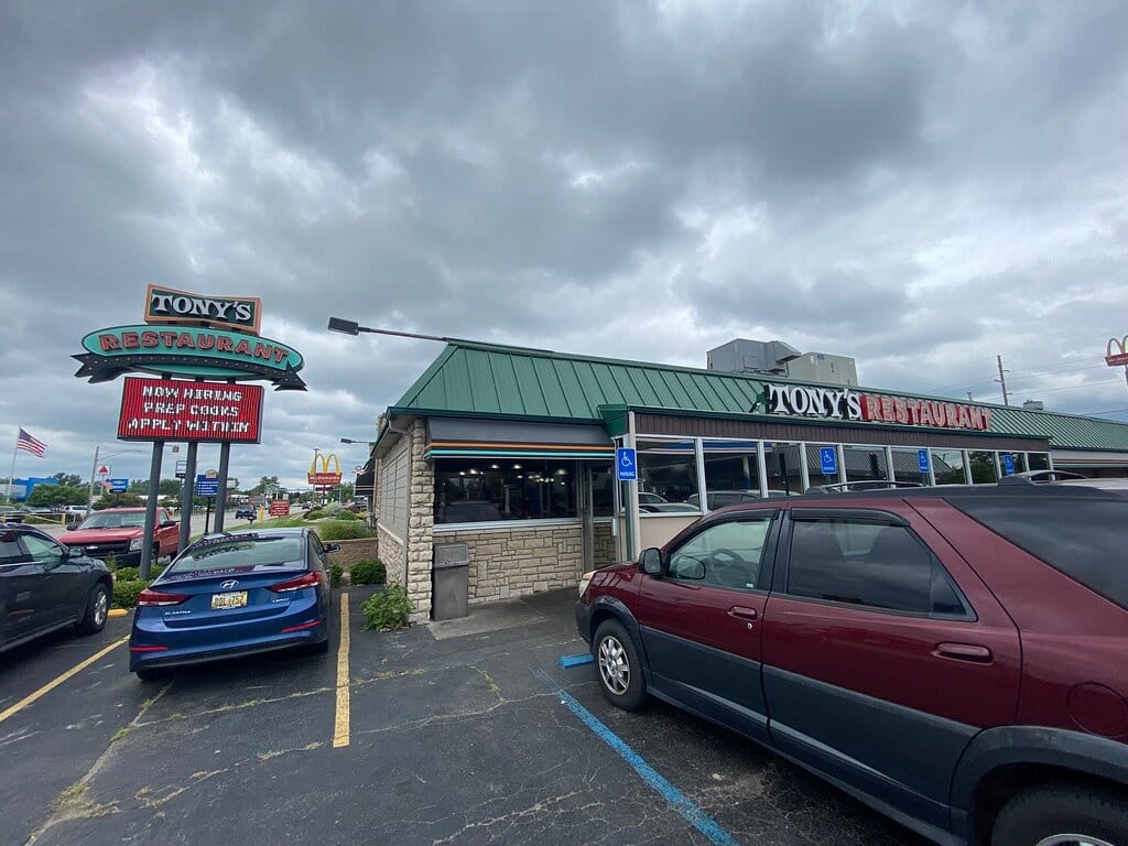 The exterior of Tony's Restaurant under a cloudy sky, showcasing the establishment's signage and entrance.