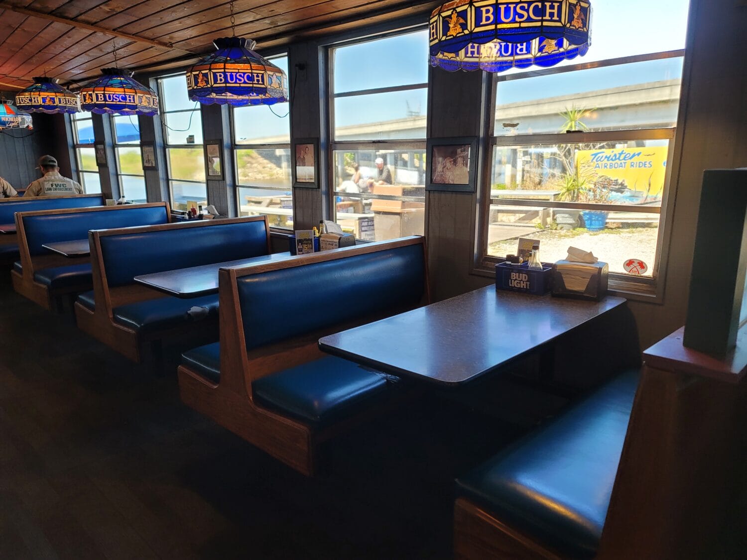 the inside dining area of the restaurant with views of the river