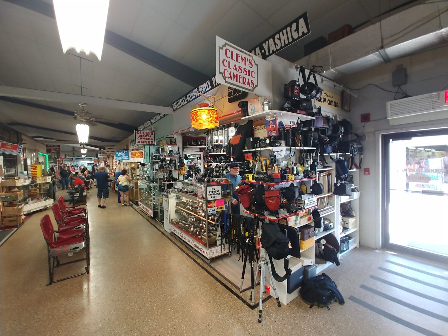 the inside of the flea market lined with stalls displaying various products