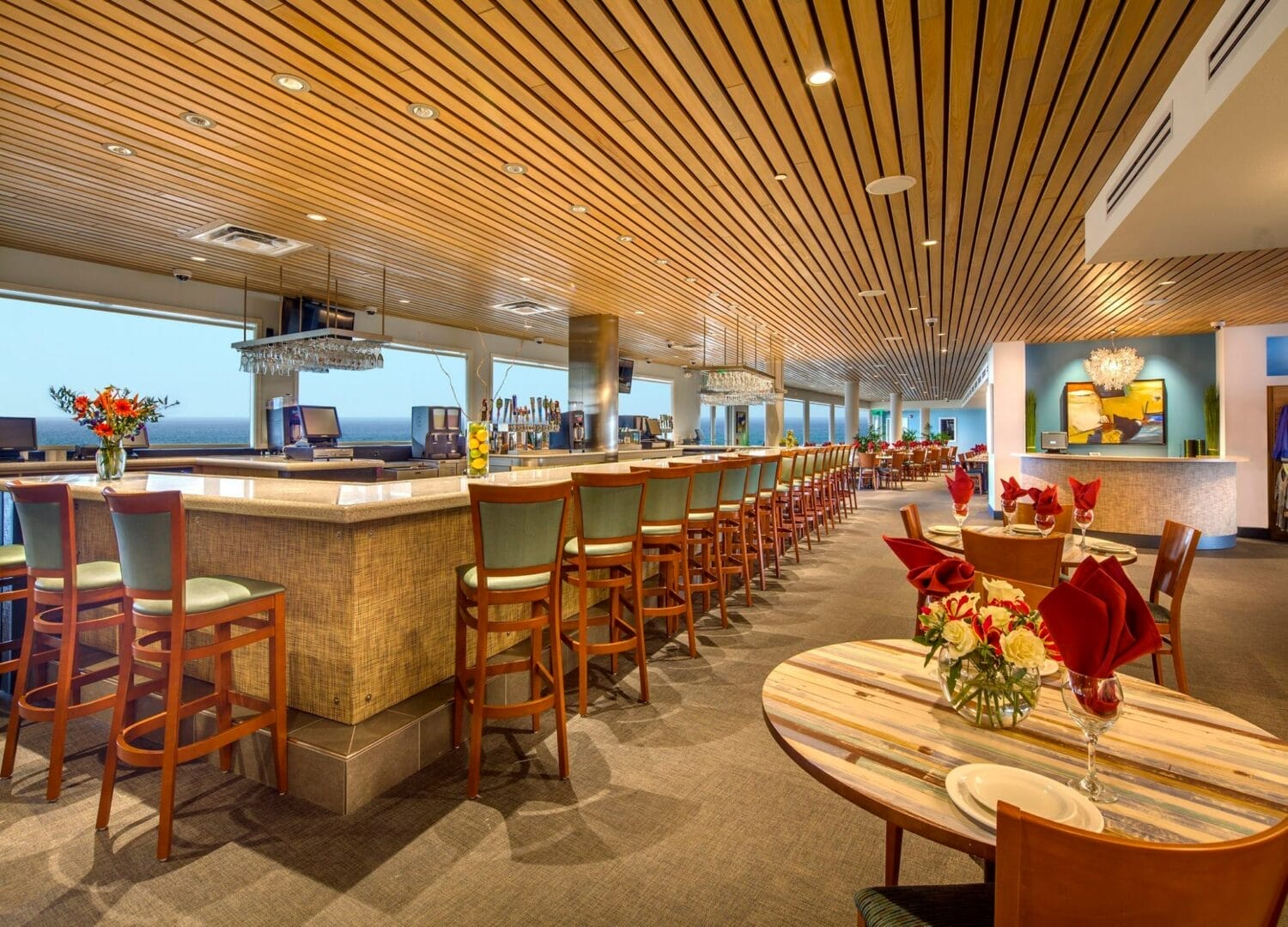 the interior of the restaurant with warm lighting a bar and fancy decors