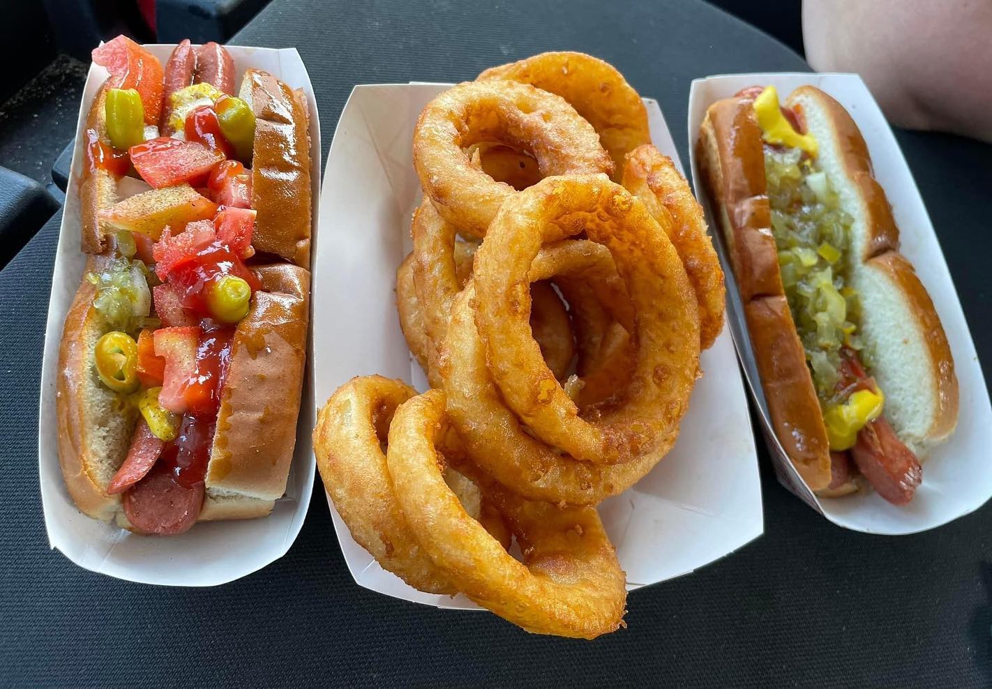 two loaded chili dogs with crispy onion rings