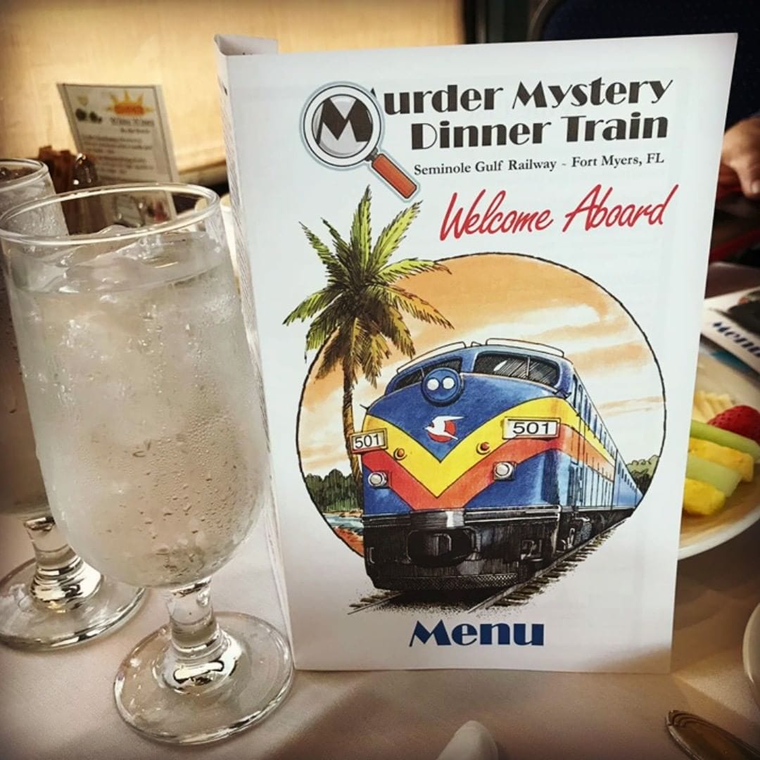 a glass of sparkling water with the menu