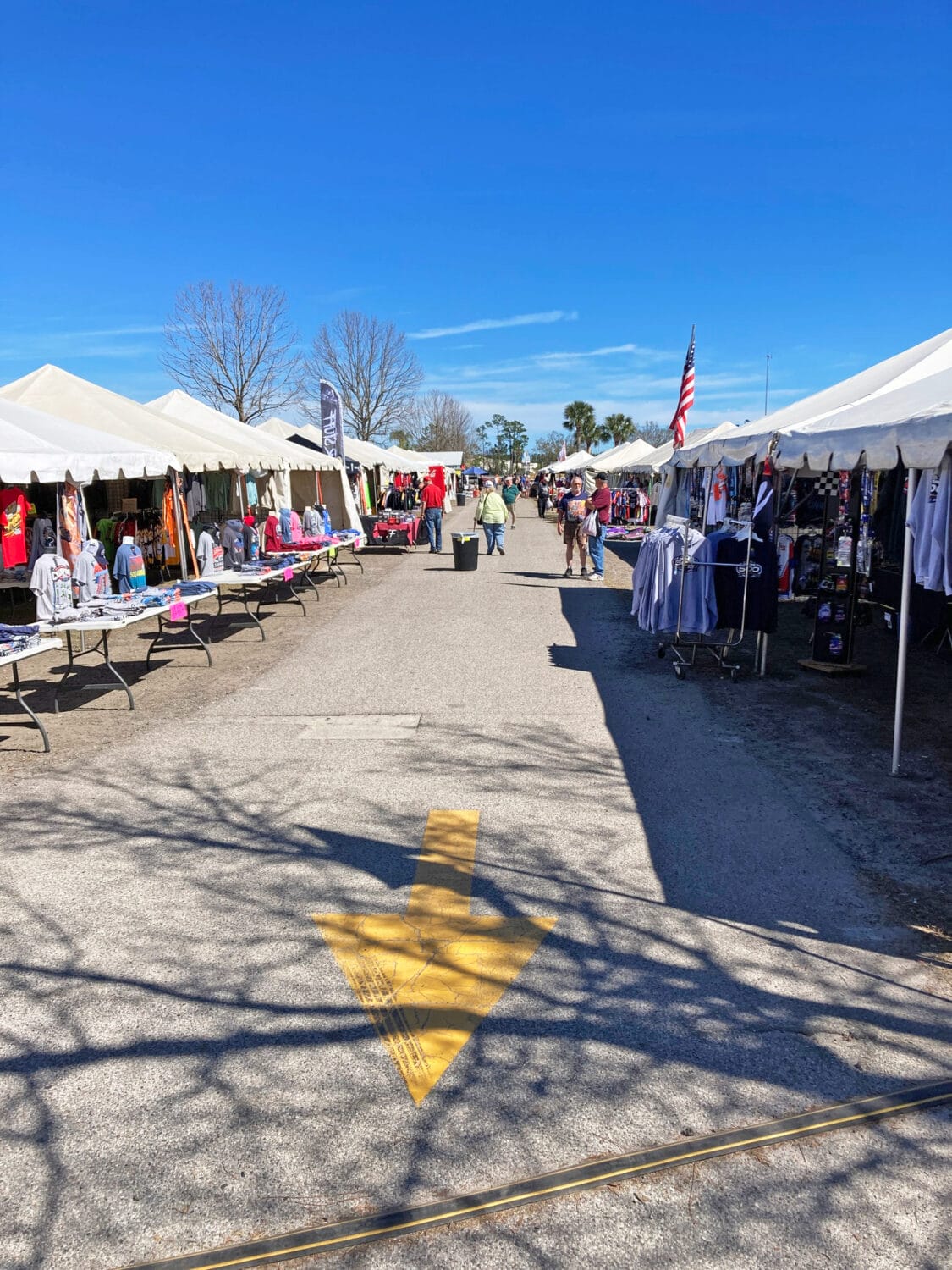 the outside of the flea market lined with various booths offering different products