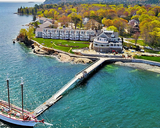 Aerial view showcasing the stunning coastline where land meets sea, with historic buildings standing sentinel over azure waters.
