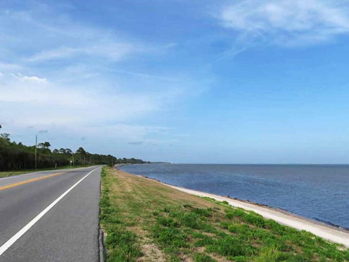 Coastal serenity personified: where the road meets the Gulf, creating nature's perfect driving soundtrack.