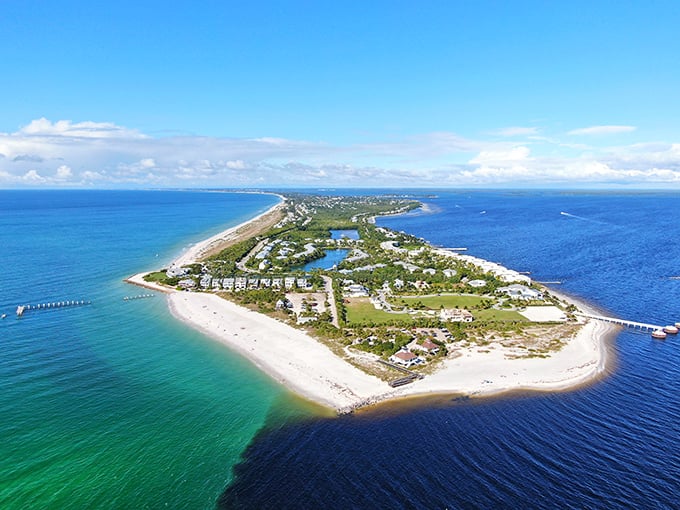 Aerial view of paradise where two shades of blue water embrace a sliver of land, creating Florida's most charming island escape.