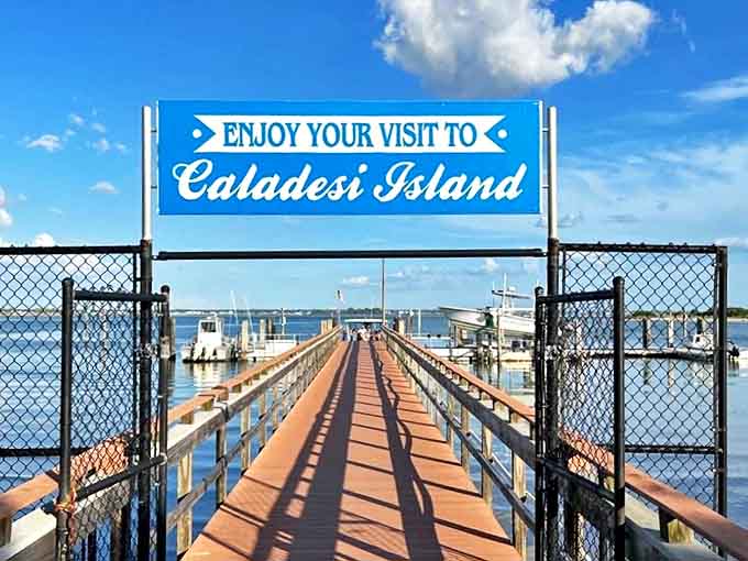Gateway to paradise: The welcoming sign at Caladesi Island's dock promises adventure while the wooden boardwalk beckons visitors forward into untouched Florida beauty.