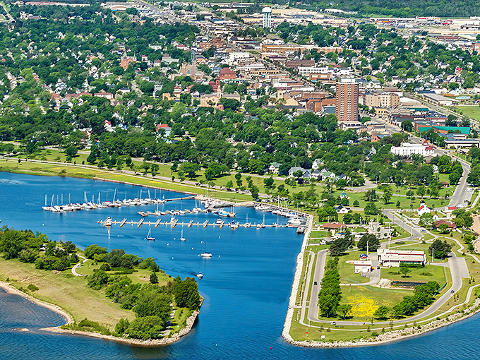 Escanaba's stunning waterfront stretches along Little Bay de Noc, where sailboats bob gently against a backdrop of lush greenery and historic architecture.