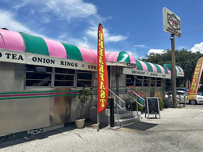 A gleaming silver railcar with candy-striped awning beckons hungry travelers like a mirage of comfort food in the Florida sunshine.