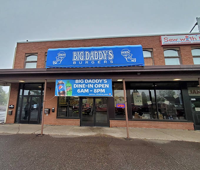The blue awning of Big Daddy's Burgers stands as a beacon of hope for hungry travelers in Duluth, promising burger nirvana from 6AM to 8PM daily.