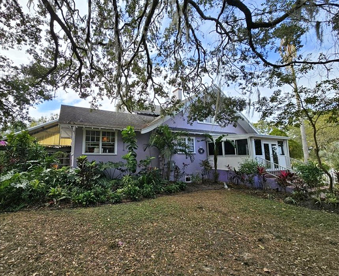 A lavender dream nestled under Spanish moss, this charming cottage promises tea-time magic before you even step inside.