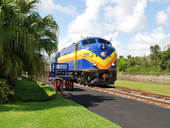 The striking blue and yellow locomotive stands ready for adventure, its vintage charm promising an evening of mystery along Florida's scenic Gulf Coast.