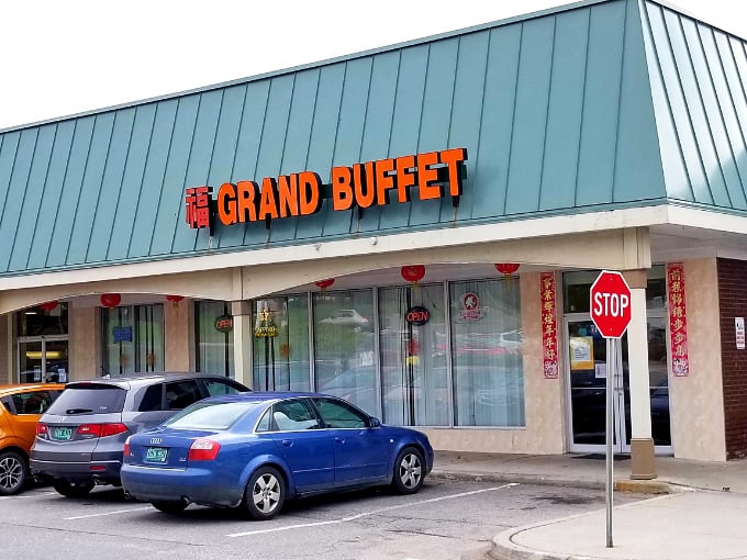 The Grand Buffet's exterior beckons with its bold red signage, promising an adventure in all-you-can-eat dining that transcends typical strip mall expectations.