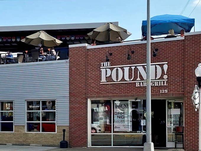 The brick facade of The Pound! Bar & Grill stands proudly on Main Street in Brighton, promising big flavors and even bigger portions.