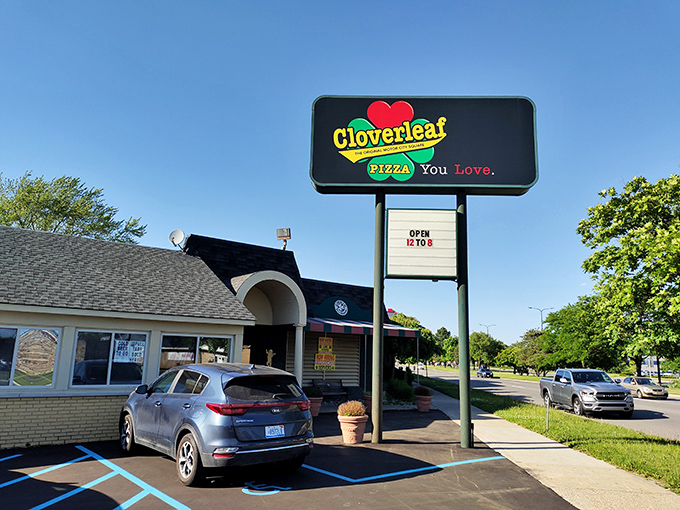 The iconic Cloverleaf sign welcomes hungry visitors to the home of Detroit's original square pizza, promising a taste of local history with every bite.