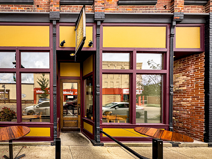 The welcoming storefront beckons with warm yellow walls and rustic wood accents, promising culinary adventures within Fennville's charming downtown.