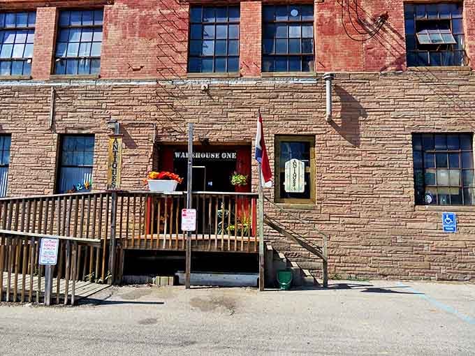 The weathered brick exterior of Warehouse One beckons treasure hunters with promises of discoveries waiting just beyond those wooden doors.
Amber glassware catches light like liquid honey, transforming ordinary shelves into a museum of domestic elegance from decades past.