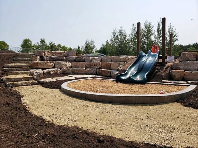 Stone steps lead to a natural slide area where childhood dreams and muddy clothes are made in equal measure.