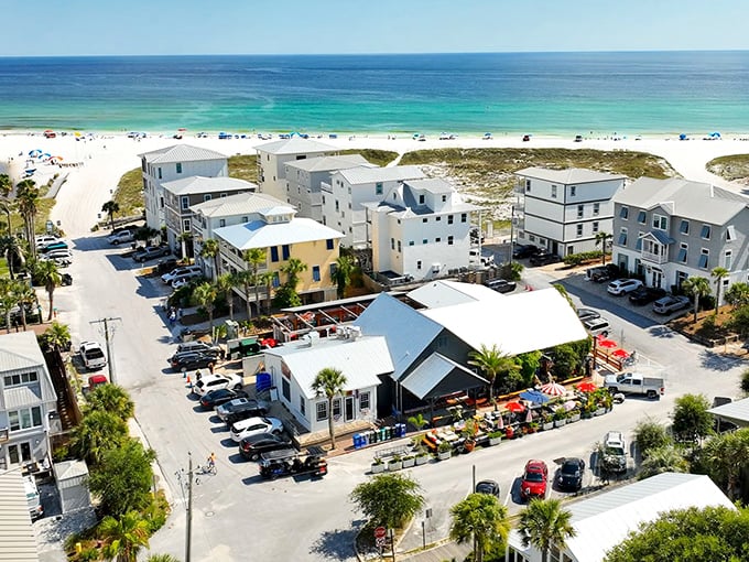 Aerial paradise where coastal charm meets laid-back luxury. Grayton Beach's white buildings stand like sentinels guarding that impossibly turquoise Gulf water.