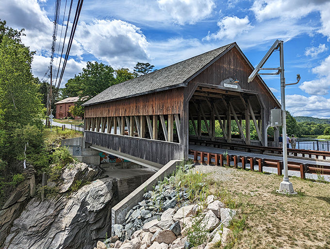 The historic Quechee Covered Bridge stands sentinel over rushing waters, its weathered timbers telling tales of Vermont's storied past.