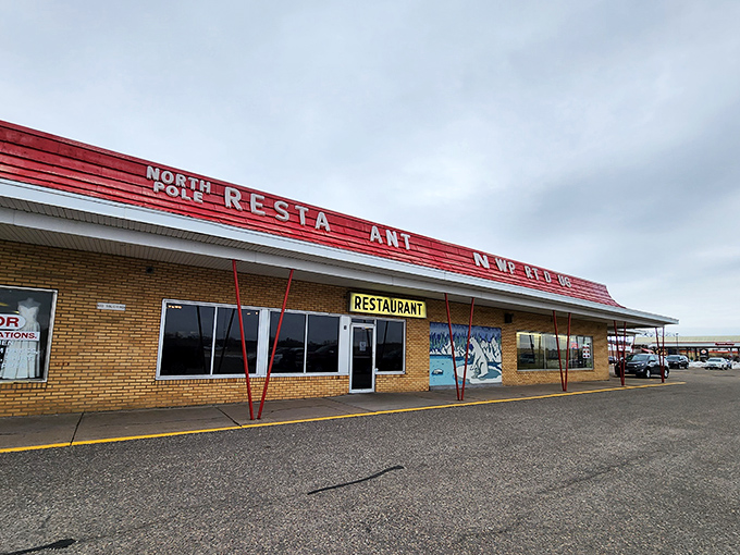 The unassuming exterior of North Pole Restaurant, where culinary magic happens behind a humble brick facade and classic red trim.