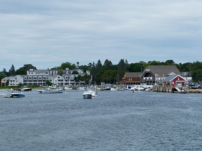 Kennebunkport's harbor view showcases classic New England charm with white clapboard buildings nestled against the water, boats gently bobbing in maritime rhythm.