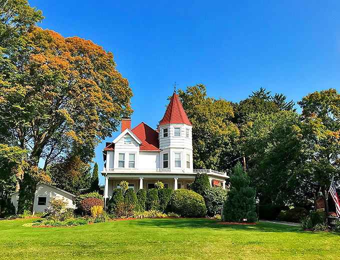 The Kingsley House stands proudly against a blue Michigan sky, its distinctive red turret announcing this isn't your average overnight stay.