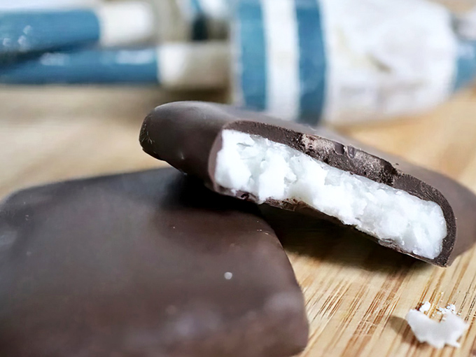 A close-up of the classic Needham reveals its secret – a creamy coconut-potato filling hiding beneath a perfect chocolate shell.