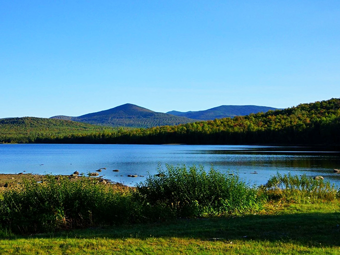 Nature's infinity pool: Moosehead Lake stretches toward mountains that seem to rise from the water itself, creating Maine's ultimate postcard moment.