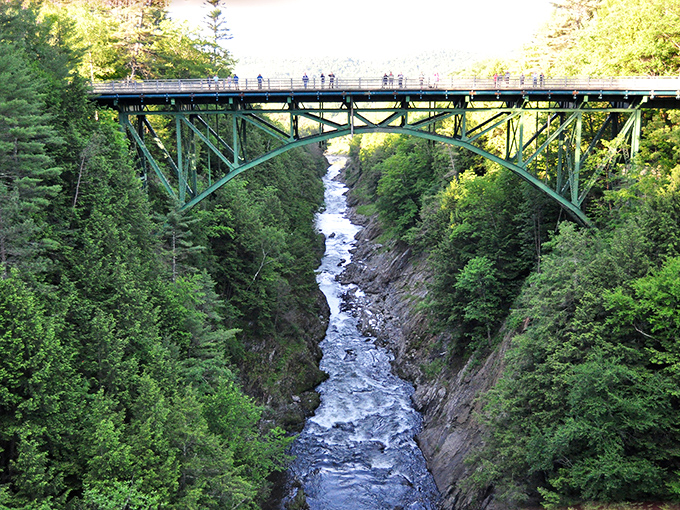 The iconic Quechee Gorge Bridge spans 163 feet above the rushing waters, making even the bravest visitors grip the railing a little tighter.