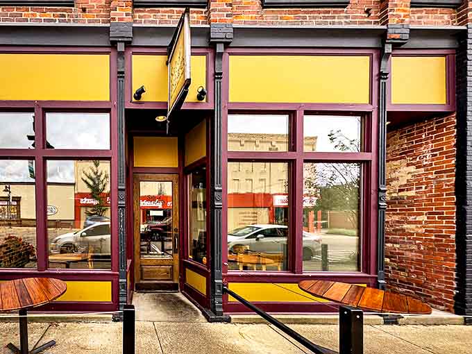 Salt of the Earth's inviting storefront beckons with warm yellow walls and burgundy trim, promising culinary treasures within this historic Fennville building.