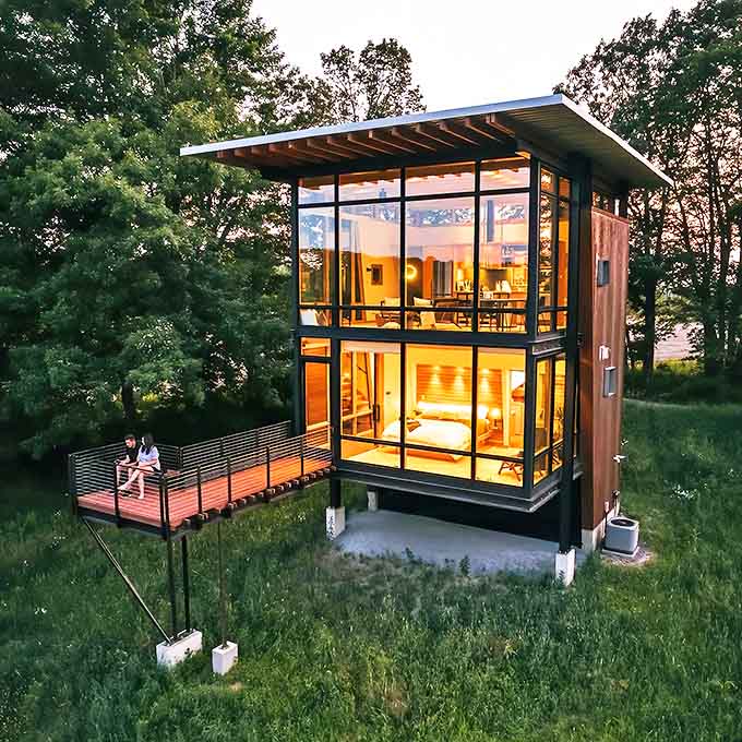 Rising from the Wisconsin wilderness like a modern-day watchtower, this glass-wrapped retreat proves that architecture and nature can be best friends who actually get along.