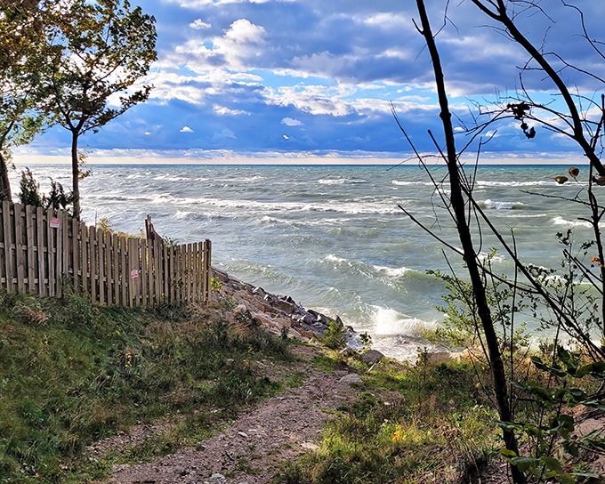 Nature's dramatic welcome mat: where forest path meets windswept dune meets the endless blue of Lake Michigan at Grand Mere.