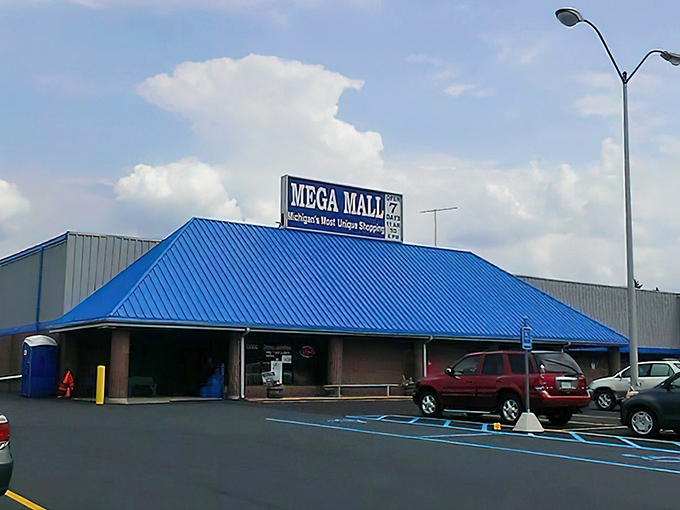 The iconic blue roof of Mega Mall stands out against Michigan skies, promising treasures that big-box retailers could never imagine housing.