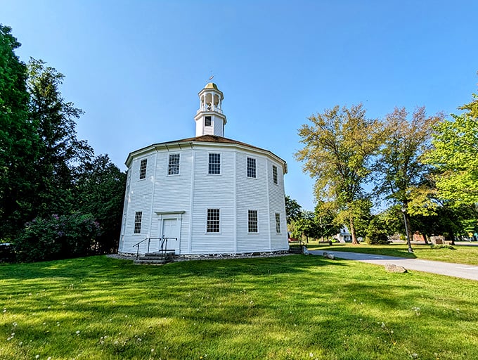 The Old Round Church stands proudly in Richmond, its sixteen-sided design creating an optical illusion of perfect roundness against Vermont's blue sky.