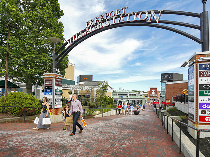 The iconic Freeport Village Station arch welcomes shoppers to Maine's retail paradise – where credit cards come to dance and wallets come to slim down.