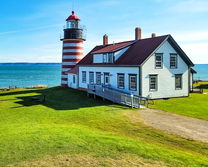 Candy-striped sentinel: West Quoddy Head Lighthouse stands proud against the Maine sky, its red and white stripes a beacon of maritime history.