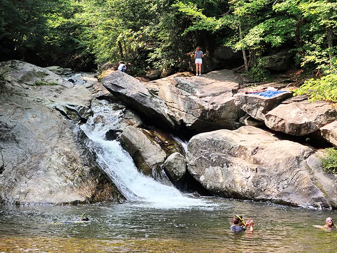 Nature's perfect waterslide: smooth rocks polished by centuries of flowing water create an exhilarating ride into crystal-clear depths below.