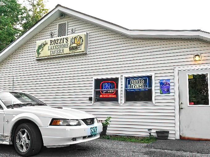 Unassuming white clapboard exterior hides Vermont's burger paradise &ndash; Rozzi's sign promises adventure while Lake Champlain whispers in the background.