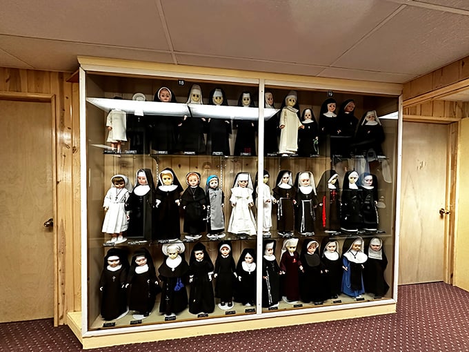 A mesmerizing display of nun dolls stands in perfect formation, their tiny habits meticulously crafted to represent various religious orders throughout history.