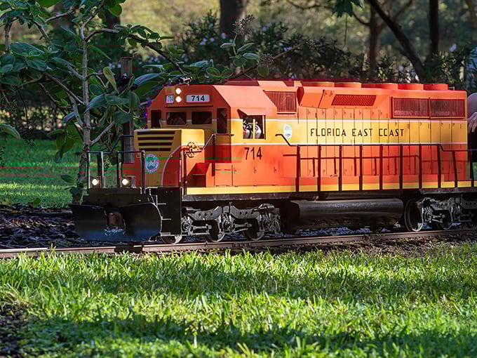 The vibrant Florida East Coast Railway locomotive #714 glides through Largo Central Park, a miniature marvel of engineering passion.