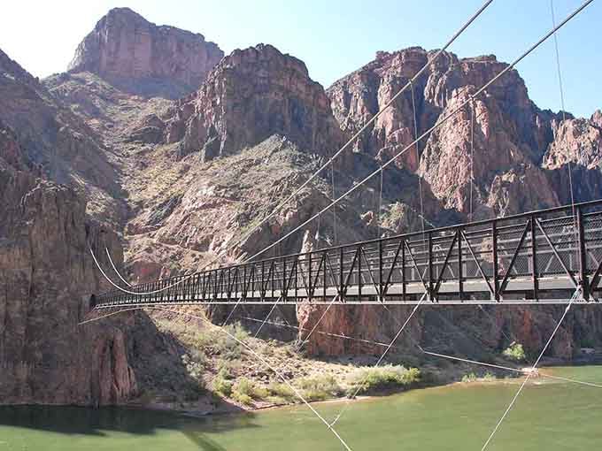 The Black Bridge spans the Colorado River like a steel ribbon, connecting adventurers to the canyon's ancient heart below.