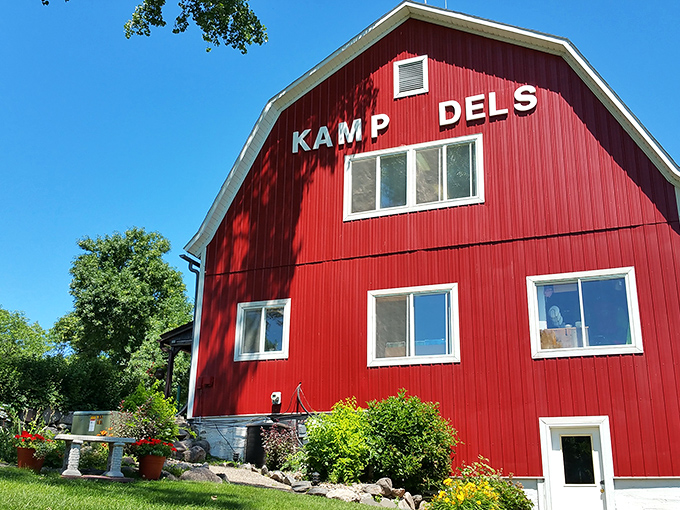 The iconic red barn of Kamp Dels stands proud against the Minnesota sky, promising adventures that generations of families have treasured.