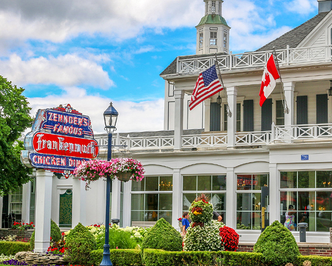 Zehnder's iconic facade stands proudly in Frankenmuth, its classic white architecture and famous neon sign beckoning hungry travelers like a chicken-scented lighthouse.