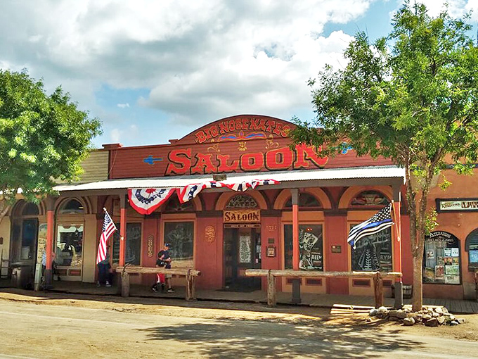The iconic red facade of Big Nose Kate's Saloon stands proudly on Allen Street, a time portal disguised as a restaurant.