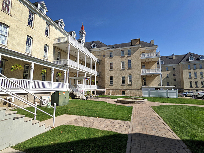 The historic cream-colored brick exterior of Trattoria Stella stands proudly, its red-capped turret a beacon for hungry travelers seeking underground Italian delights.