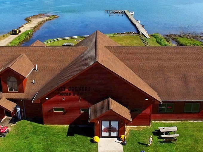 Aerial view of Cozy Corners' rustic red cabin perched perfectly on the St. Marys River – Mother Nature's dining room with a view that beats any city skyline.