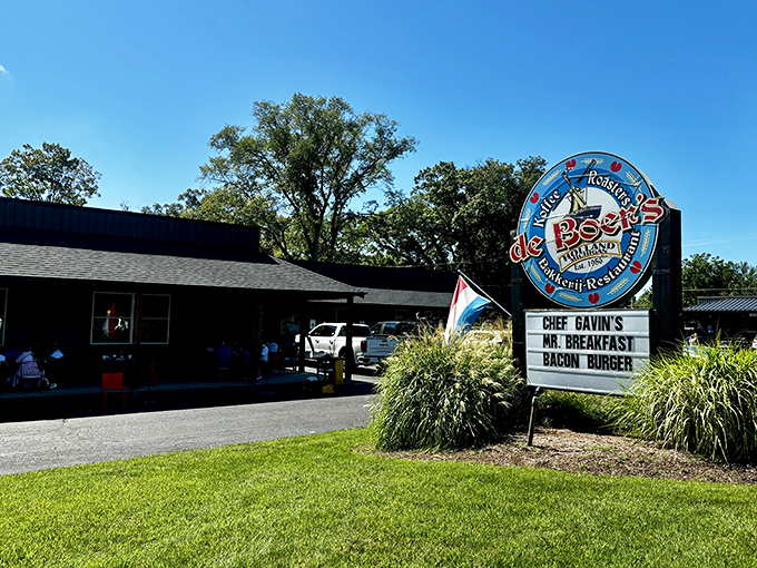 The iconic blue windmill sign of DeBoer's stands proud against Michigan skies, promising Dutch delights that'll make you forget you're stateside.